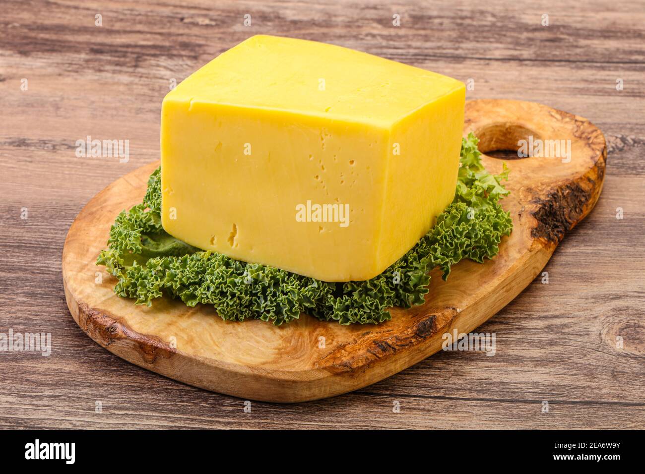 Yellow tilsiter cheese dairy product brick Stock Photo - Alamy