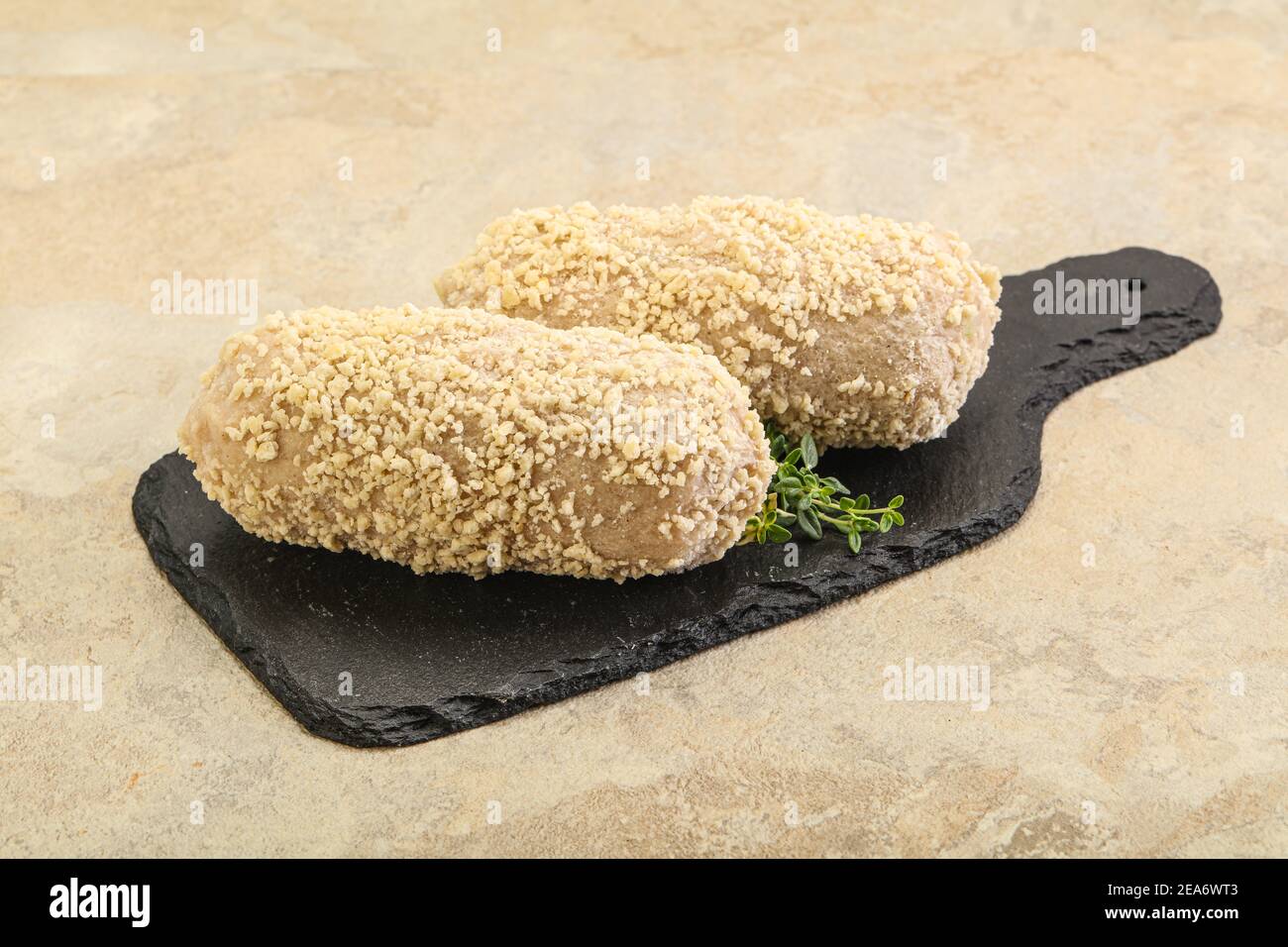 Raw breaded chicken cutlet for roast Stock Photo - Alamy
