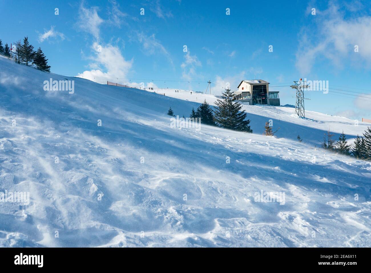 Blowing snow over snowy surface on top of mountain in Switzerland ...