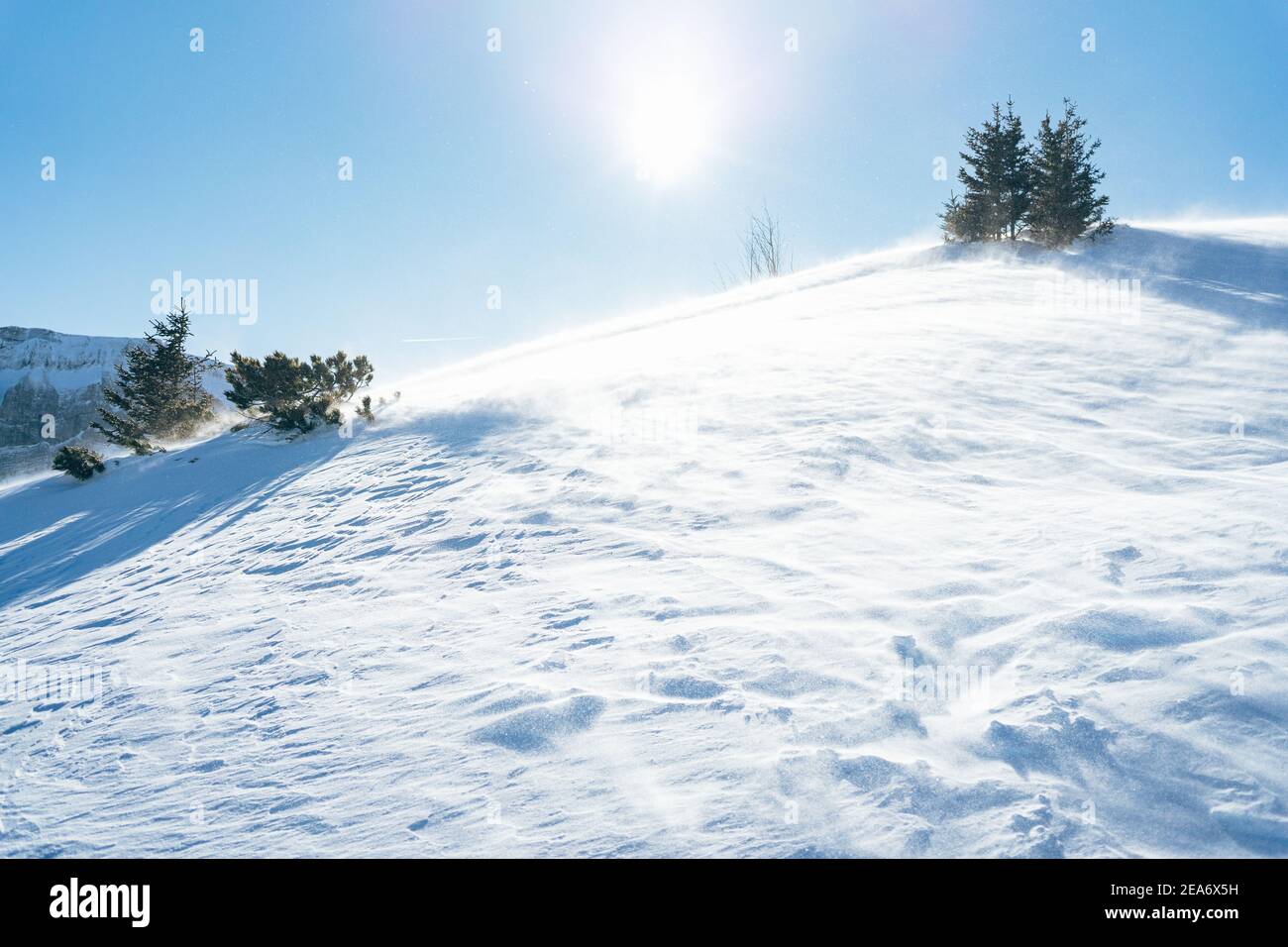 Blowing snow over snowy surface on top of mountain in Switzerland ...