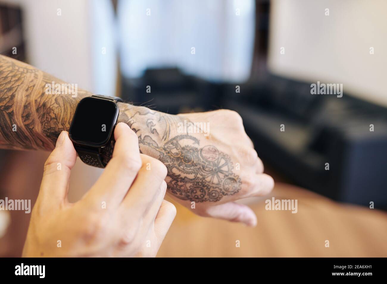 Man checking smartwatch Stock Photo - Alamy