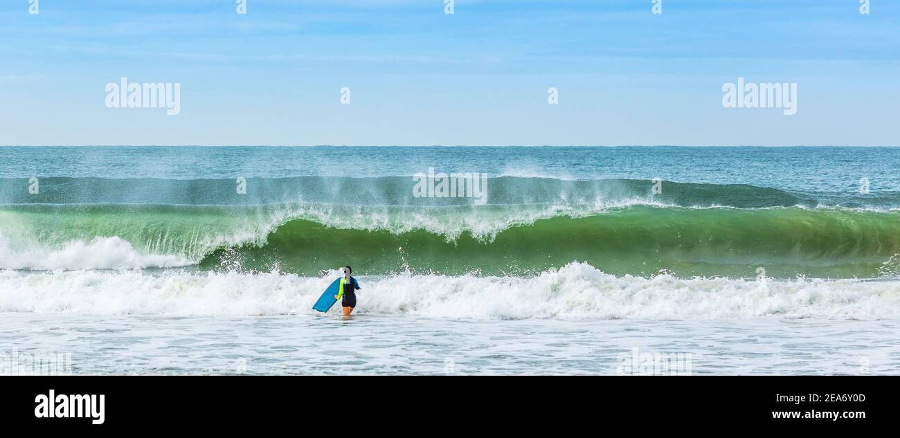 Person surfing in a wavy sea on the Brazilian beach during a daytime ...