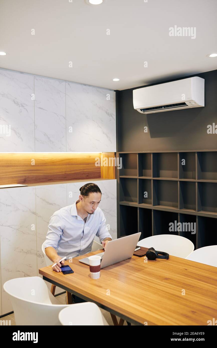 Man working in meeting room Stock Photo - Alamy