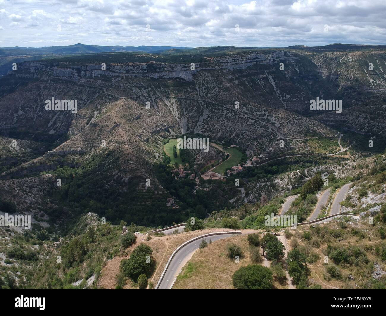 Aerial shot of landscapes with curvy roads and forests on the hill ...