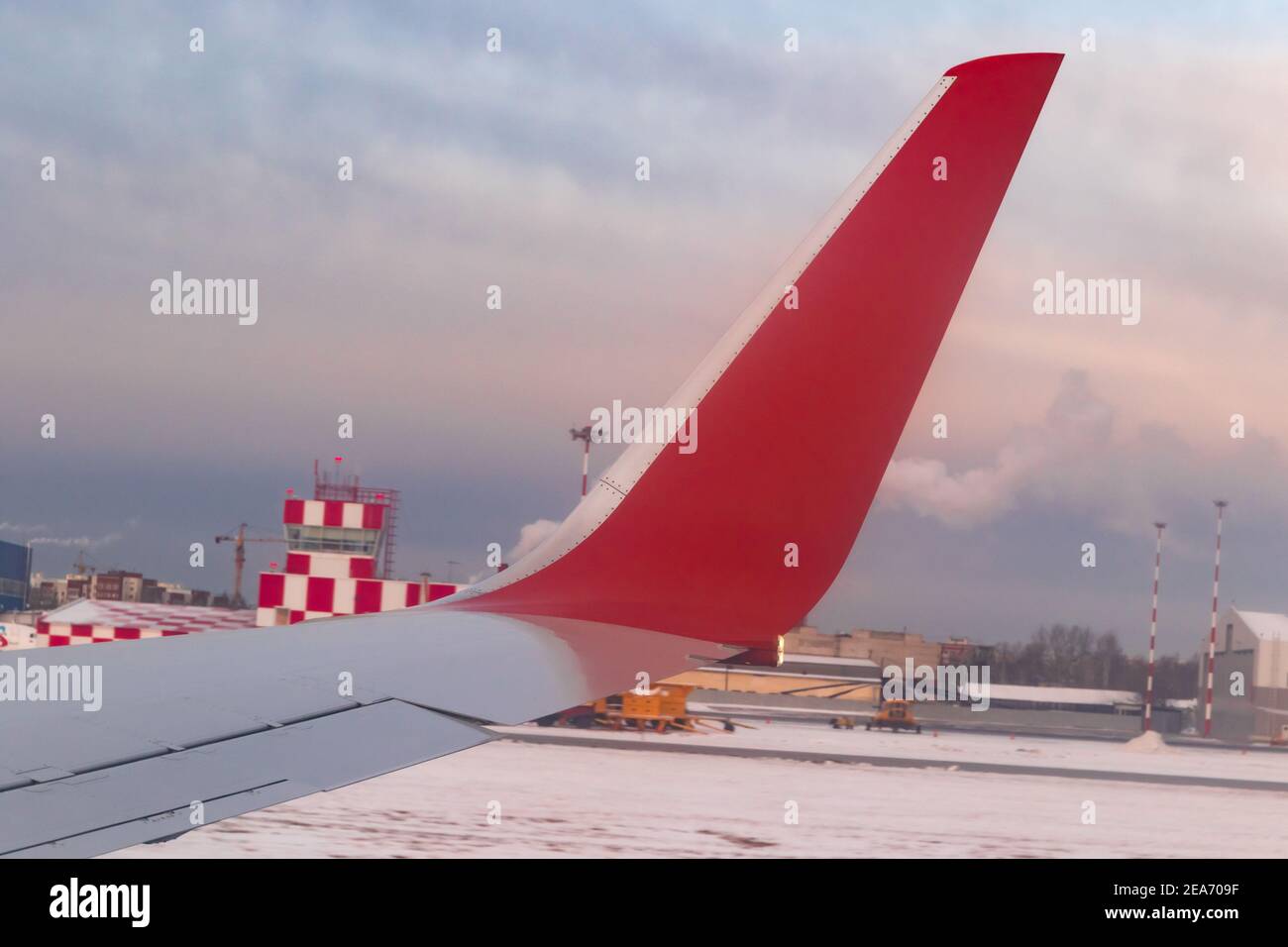 view from the airplane window of the airport runway and part of the ...