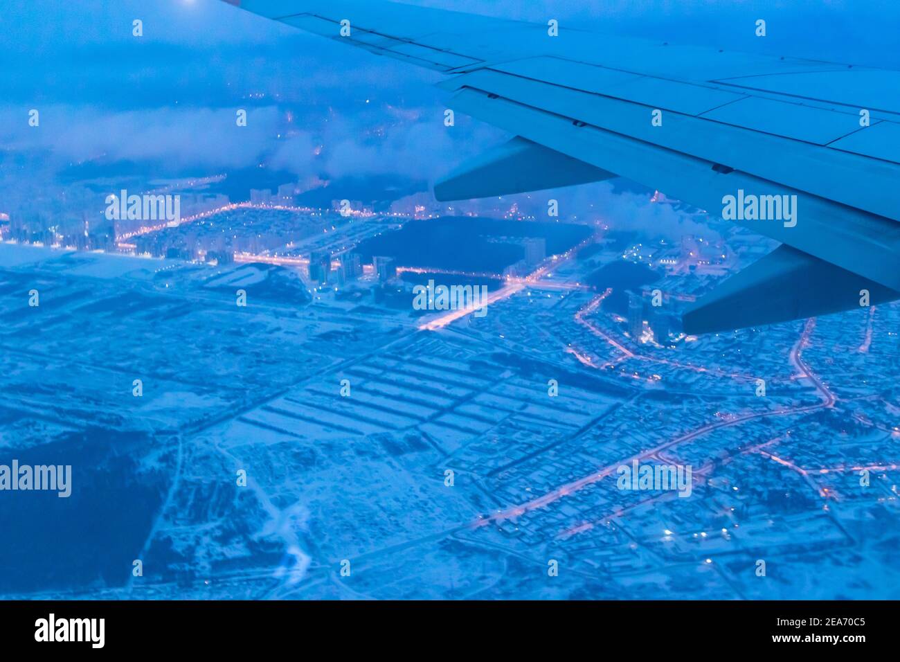 top view from a height of flight on the night city from the window of ...