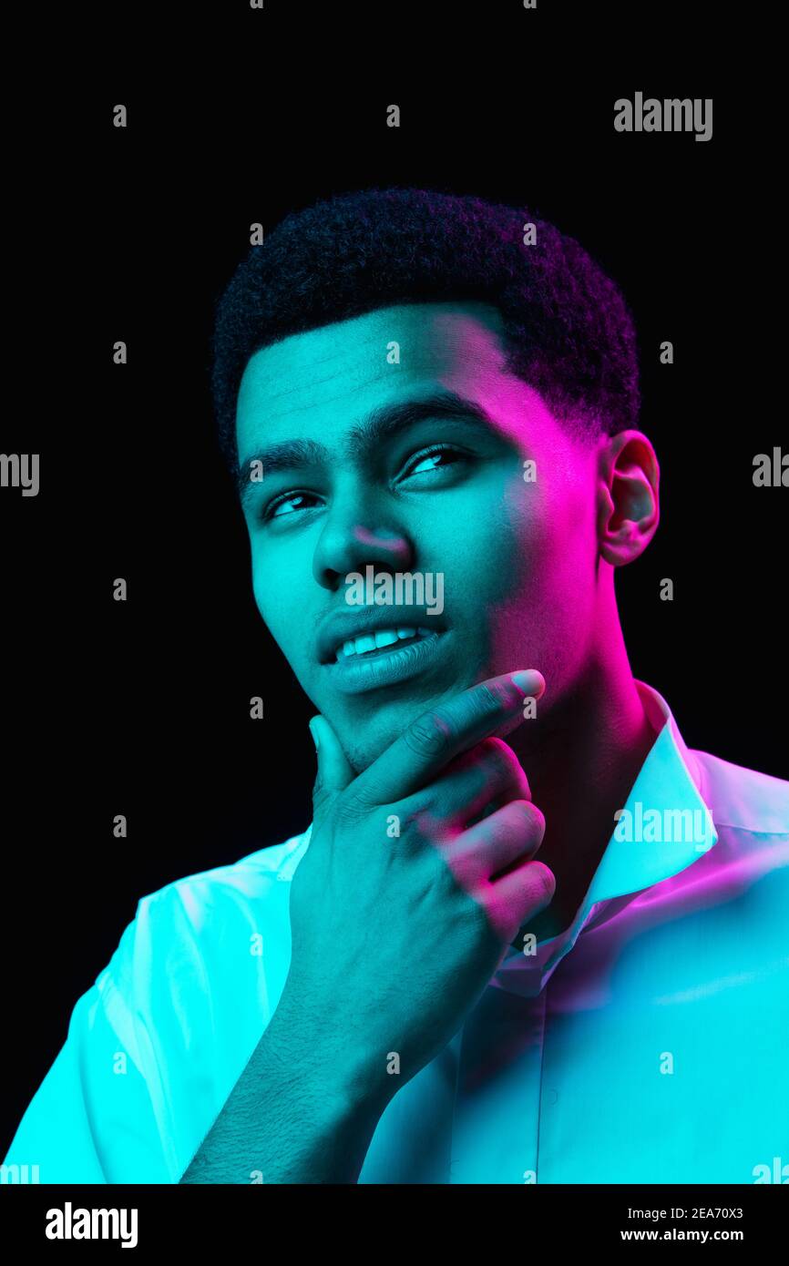 Thoughtful. African-american man's portrait on black studio background ...