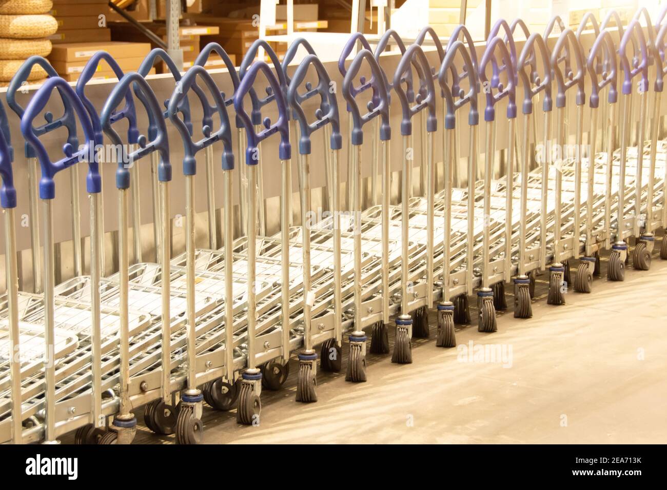 Warehouse storage of a retail store. Row a variety of Shopping Carts ...