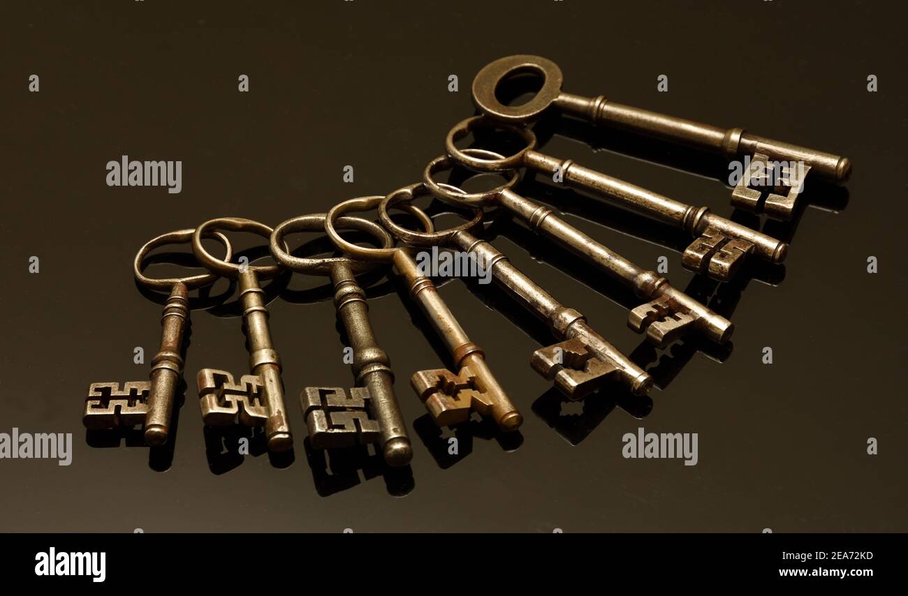 Eight Antique keys on black background Stock Photo - Alamy