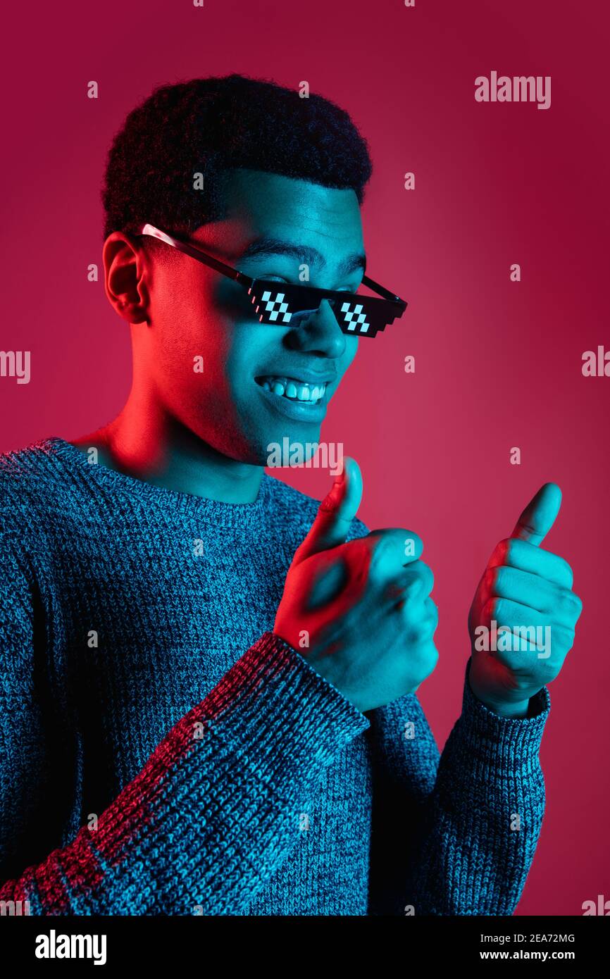 Cool pixel. African-american man's portrait on red studio background in ...