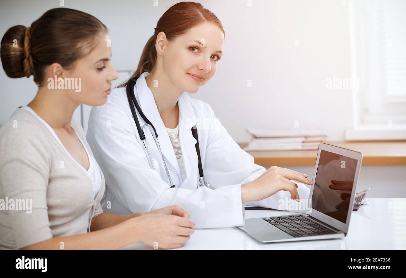 Doctor and patient sitting and discussing health examination results ...