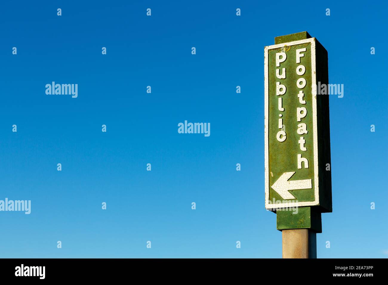 Public Footpath sign, close up, with white arrow pointing in the ...