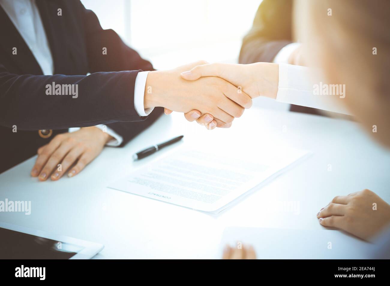 Business people shaking hands finishing up meeting or negotiation in ...
