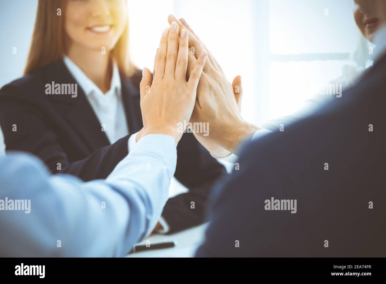 Business people happy showing teamwork and giving five showing unity ...