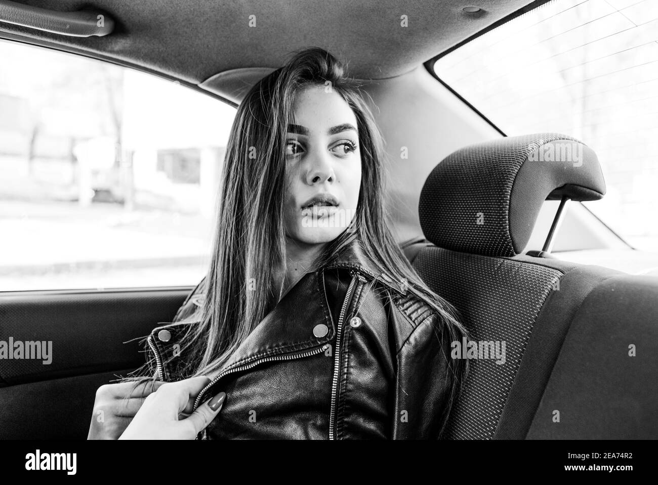 Girl rides in a car sitting in the back seat of the car. Concept ...