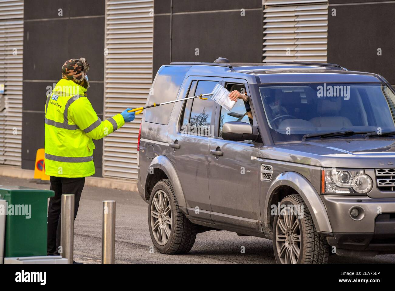 Testing staff retrieve completed kits from motorists attending a surge ...