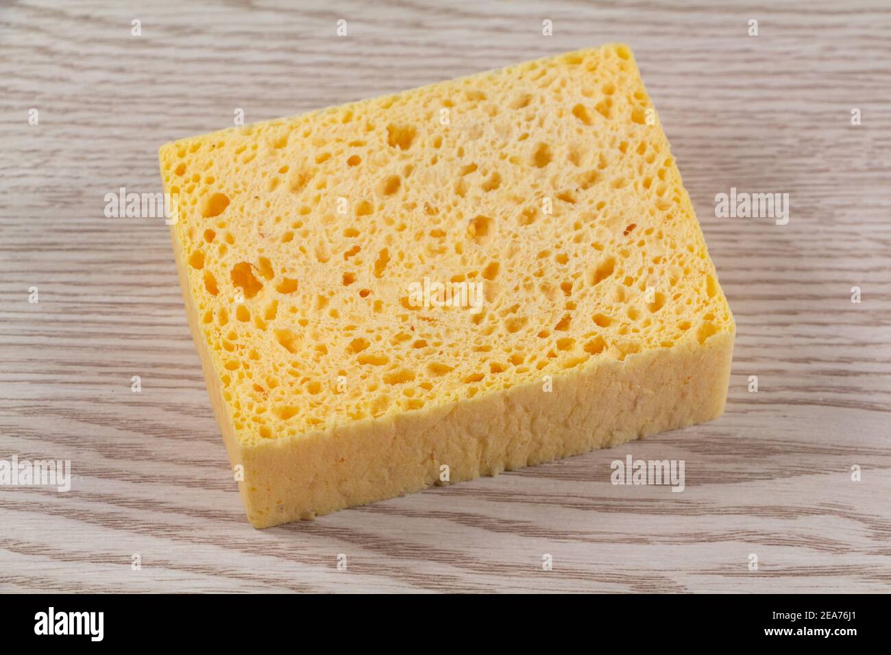 Yellow rectangular synthetic sponge on wooden background Stock Photo ...
