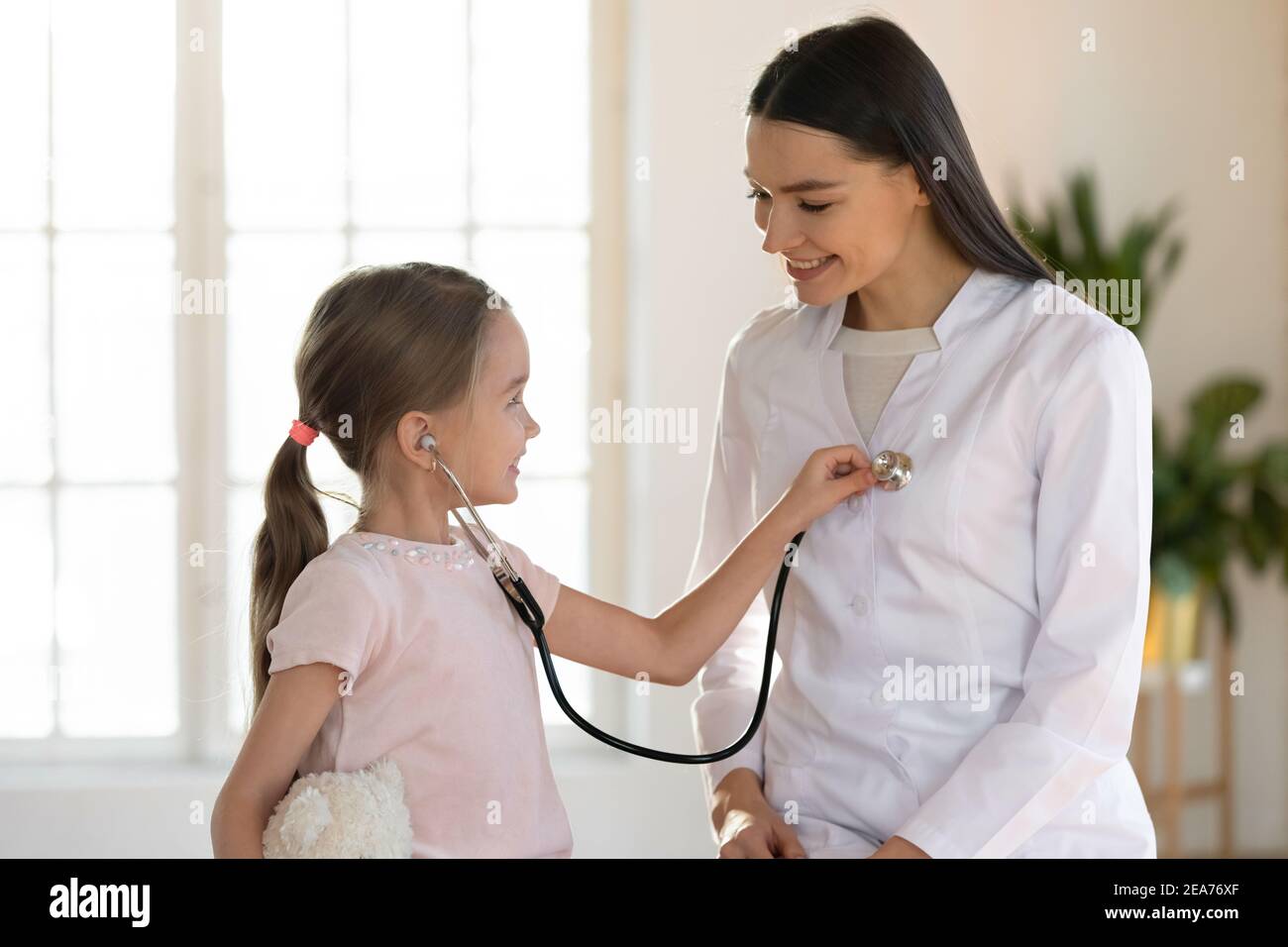 Caring female nurse play with small kid patient Stock Photo - Alamy