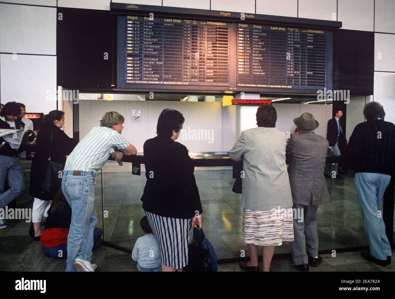 Arrivals with airline arrivals board, Heathrow Airport, 1980s Stock ...