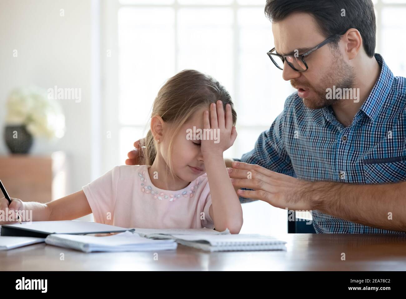 Caring young dad support upset little daughter studying Stock Photo - Alamy