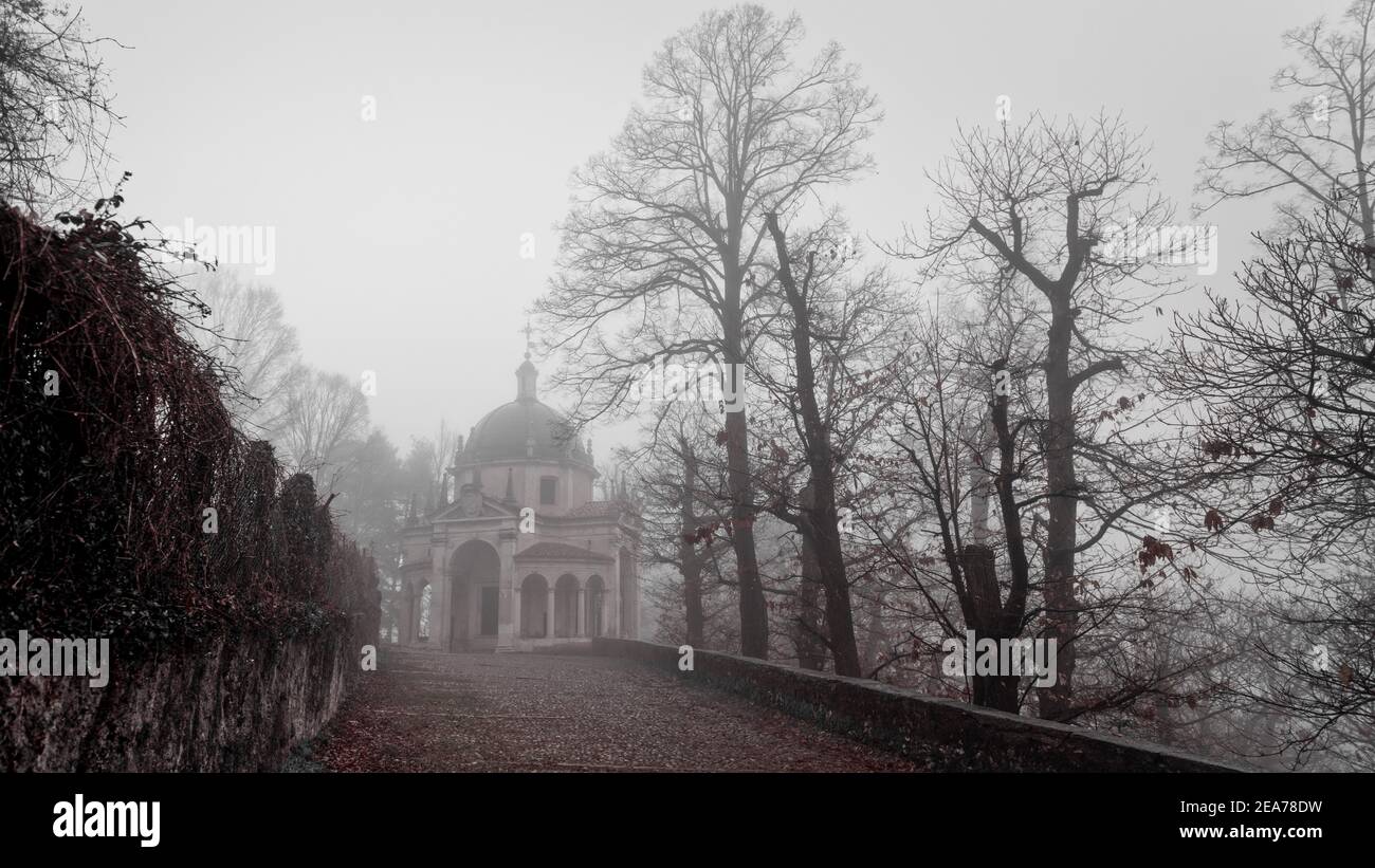 Foggy winter morning on the mountain path of Sacred Mount of Varese ...