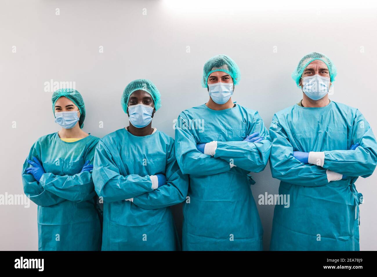 Portrait of medical doctors looking at camera inside hospital corridor ...