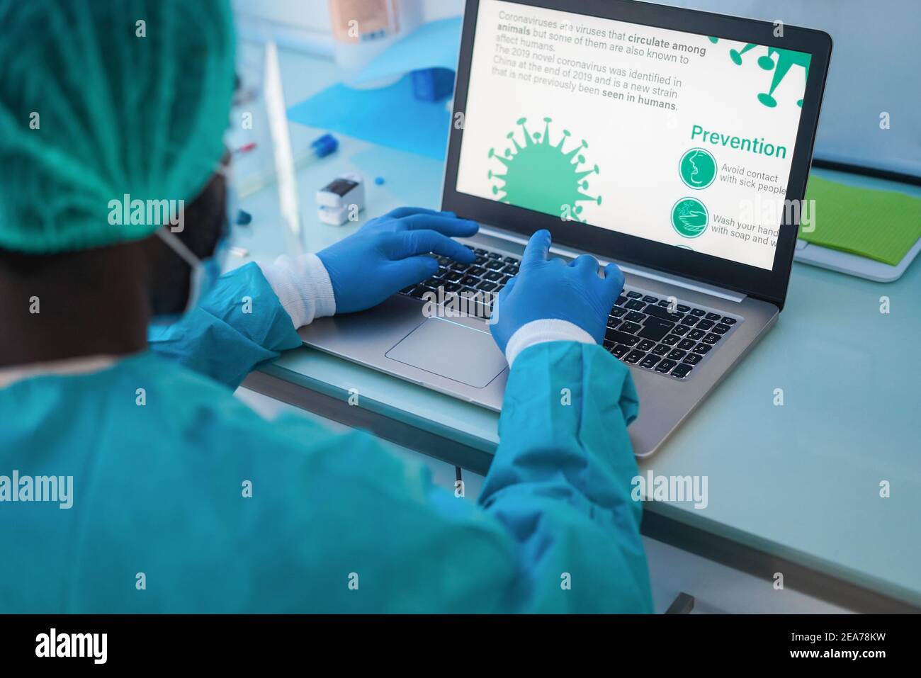 African man doctor working with laptop computer inside laboratory ...