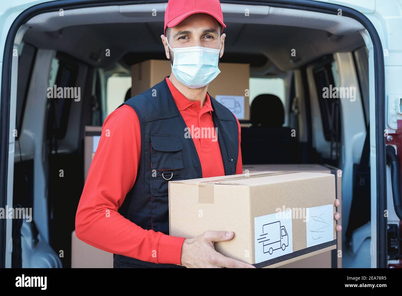 Hispanic delivery man wearing safety mask for coronavirus prevention ...