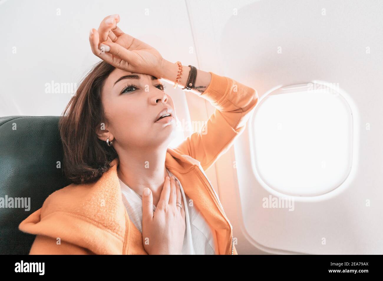 Suffocating asian woman is flying on an airplane and suddenly felt a ...