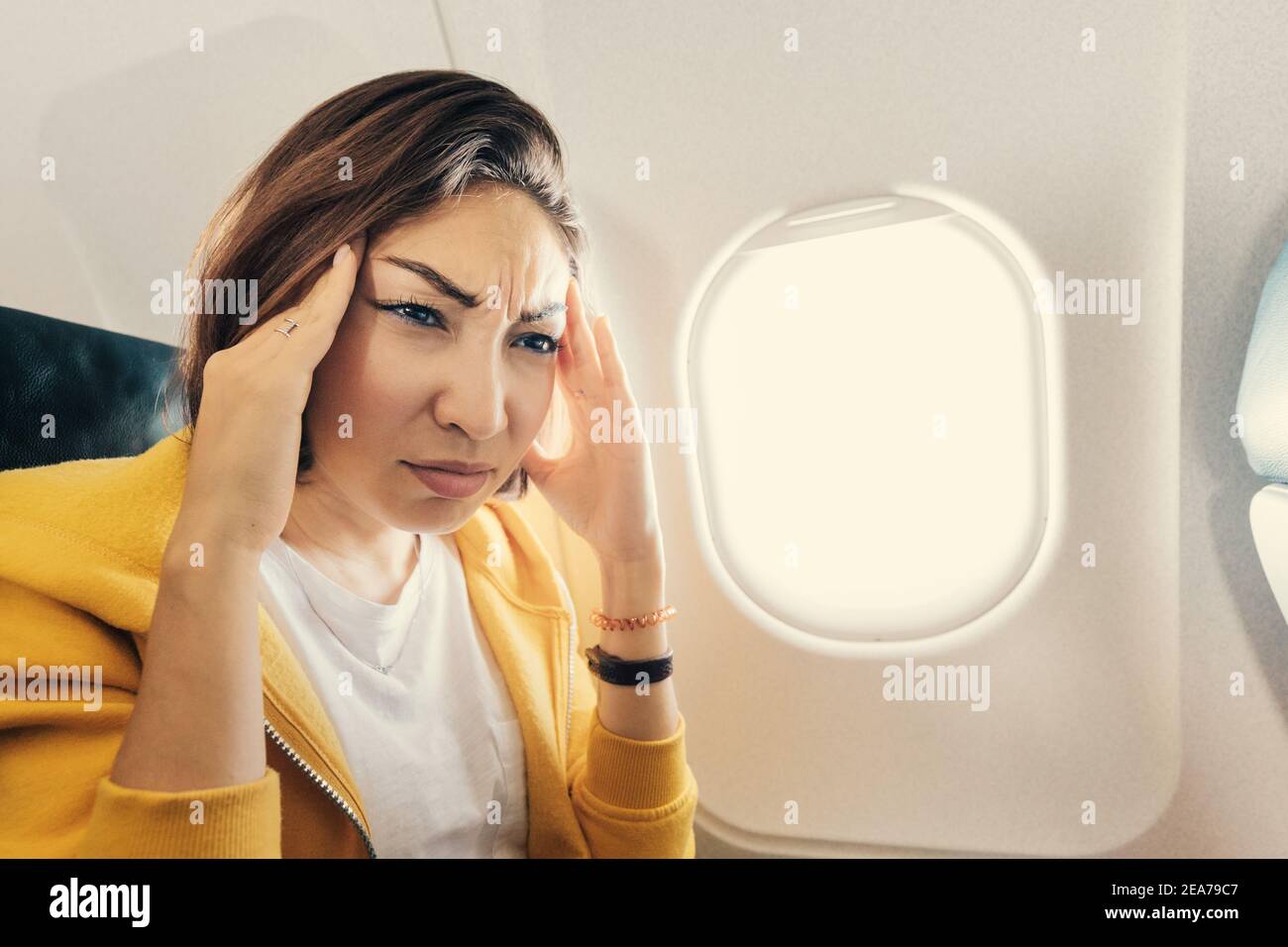 Suffocating asian woman is flying on an airplane and suddenly felt a ...