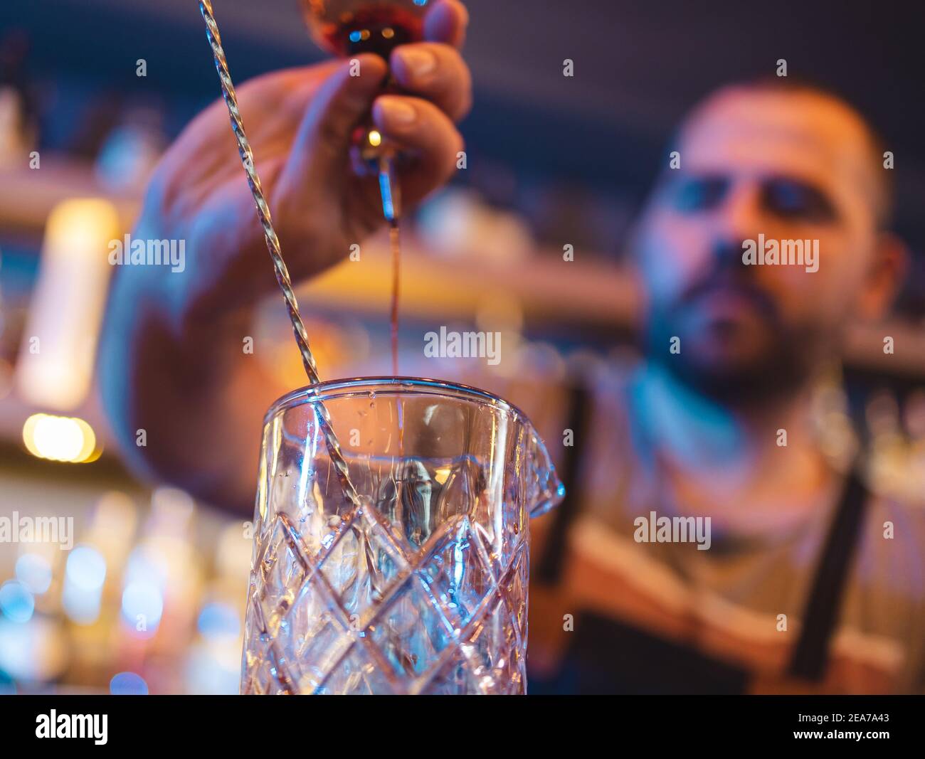 Barman pouring alcohol into empty glass to make drink in pub Stock ...