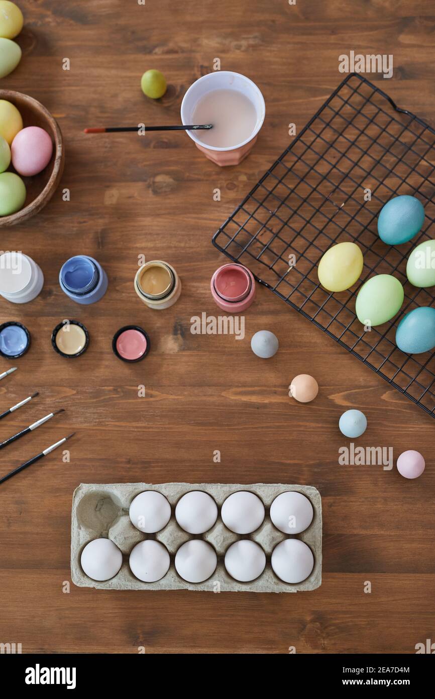 Vertical top view background of pastel colored Easter eggs on wooden ...