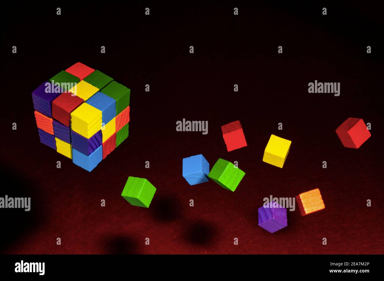 Colorful flying cubes in red background Stock Photo - Alamy