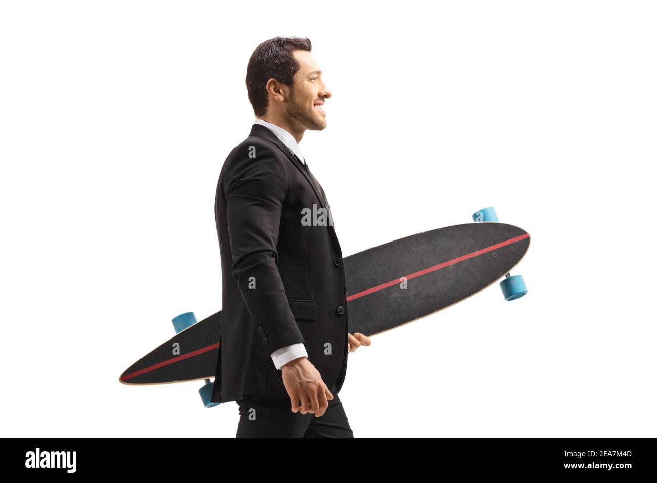 Young businessman in a suit walking and carrying a longboard isolated ...