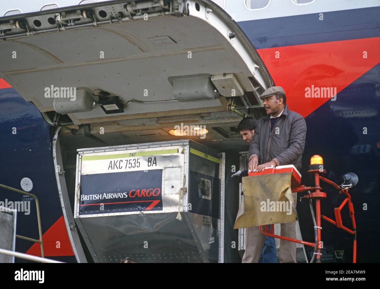 British Airways Jumbo jet luggage pods at Heathrow Airport airside ...