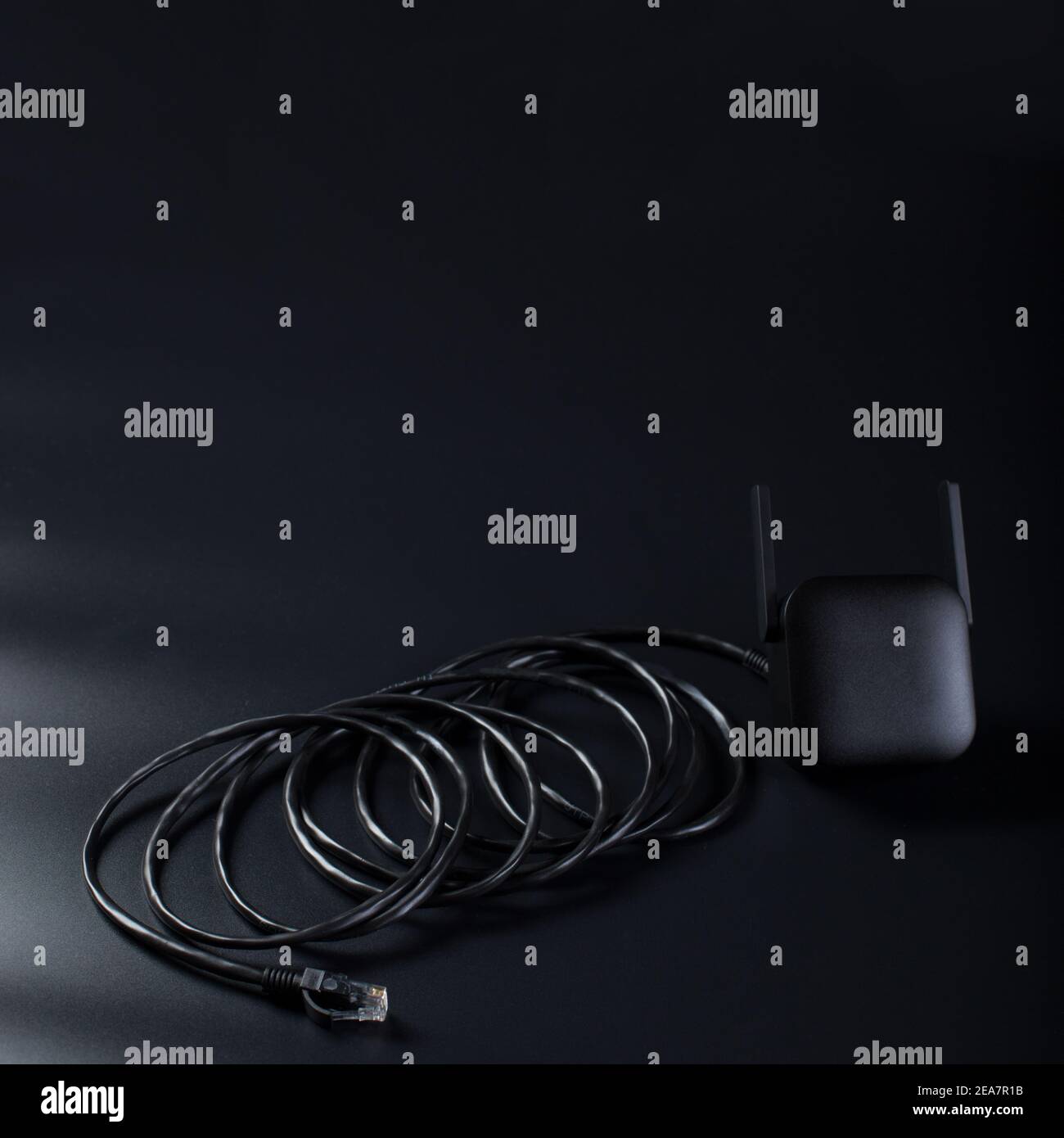 Black wifi router with black patch cord on black background Stock Photo ...