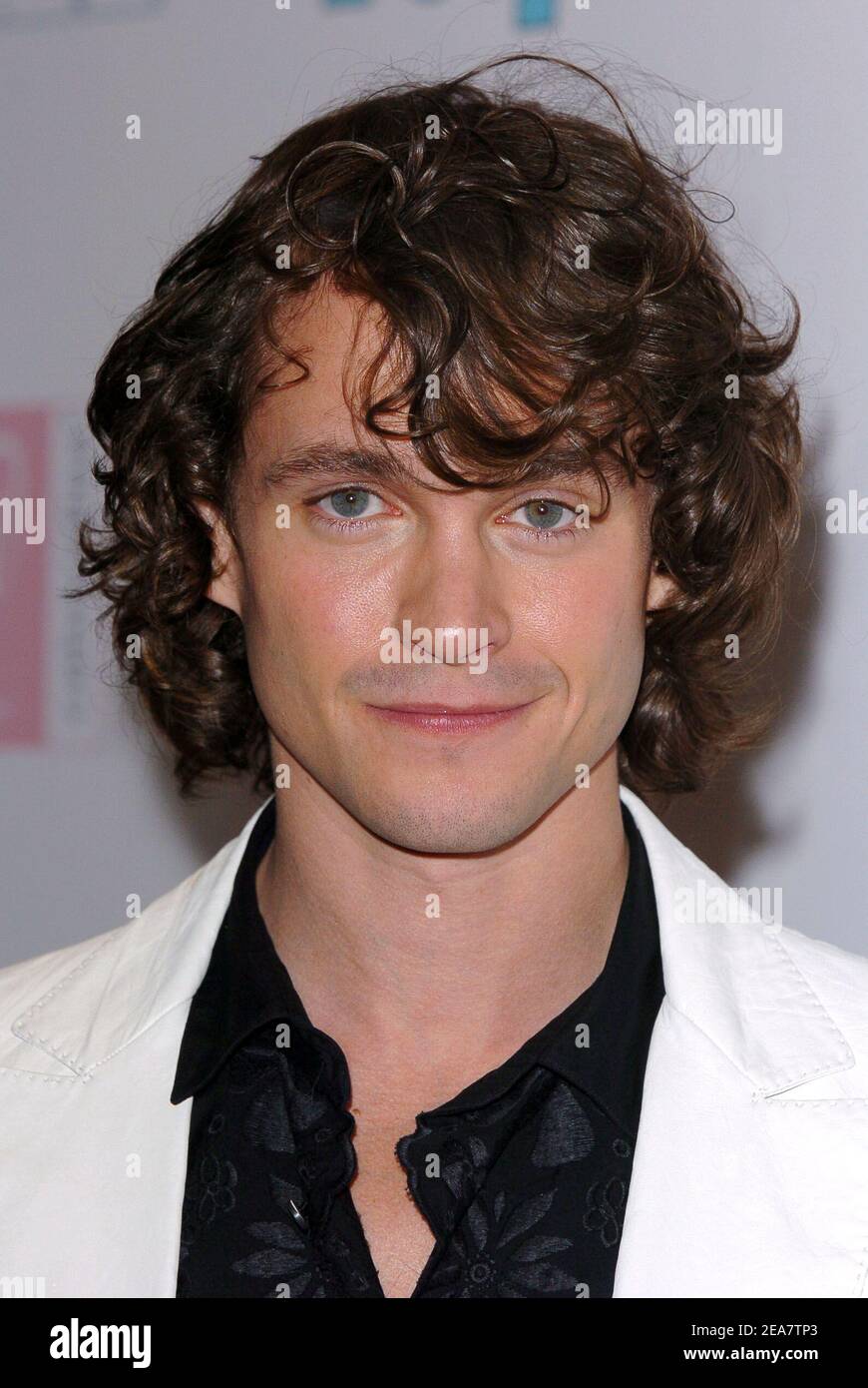Hugh Dancy poses as he arrives at the Ella Enchanted premiere held at ...
