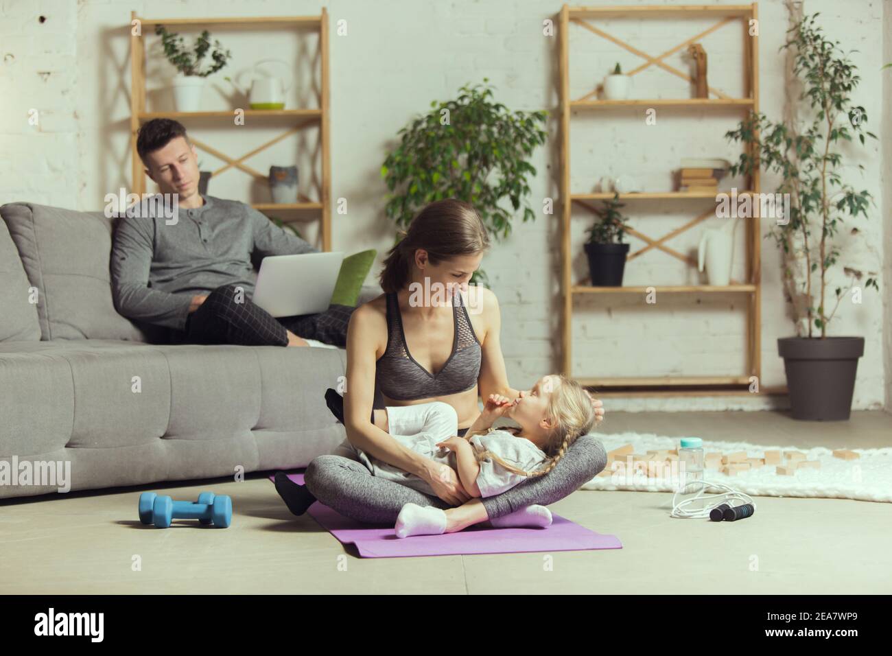 Workout ABS with daughter. Young woman exercising fitness, aerobic ...