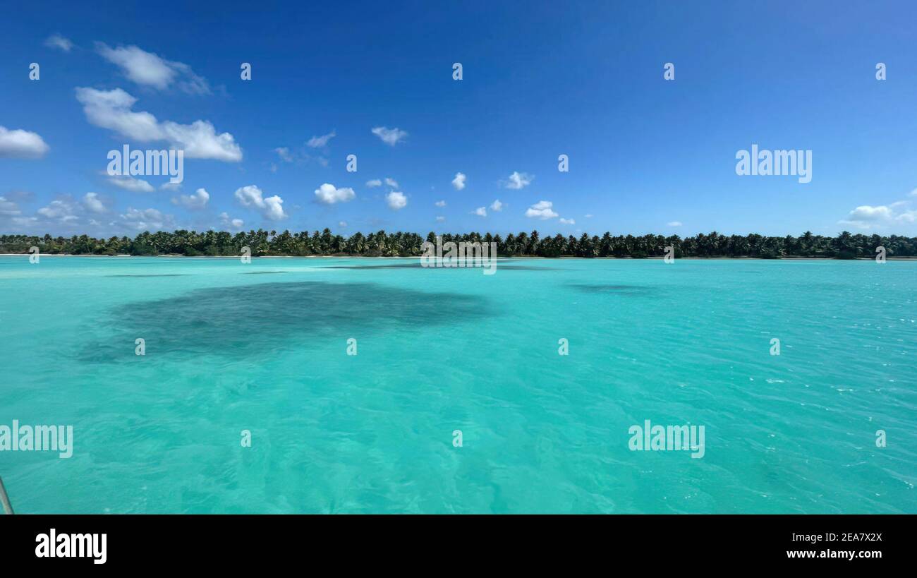 Ocean or sea calm water surface under a blue sky with a few clouds ...