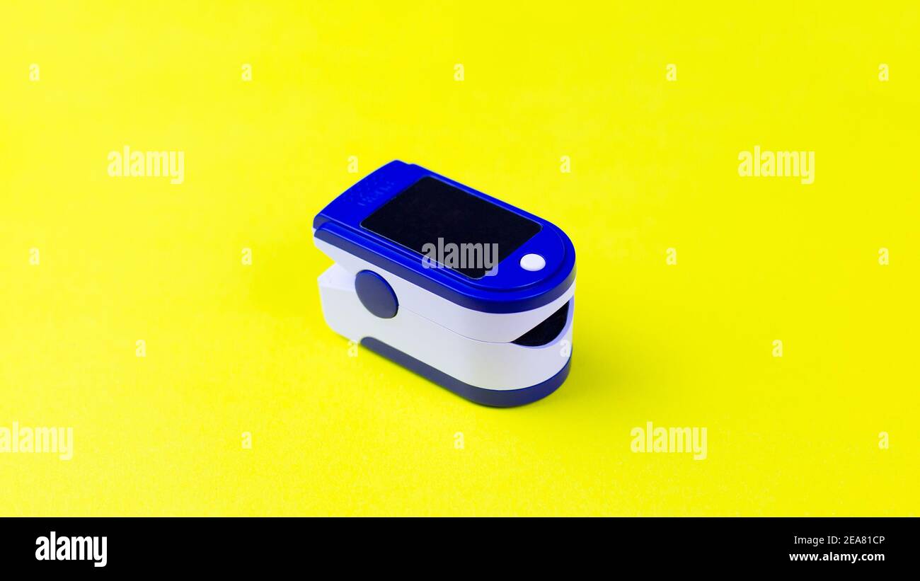 Home oximeter pulse oximeter on yellow background Stock Photo - Alamy