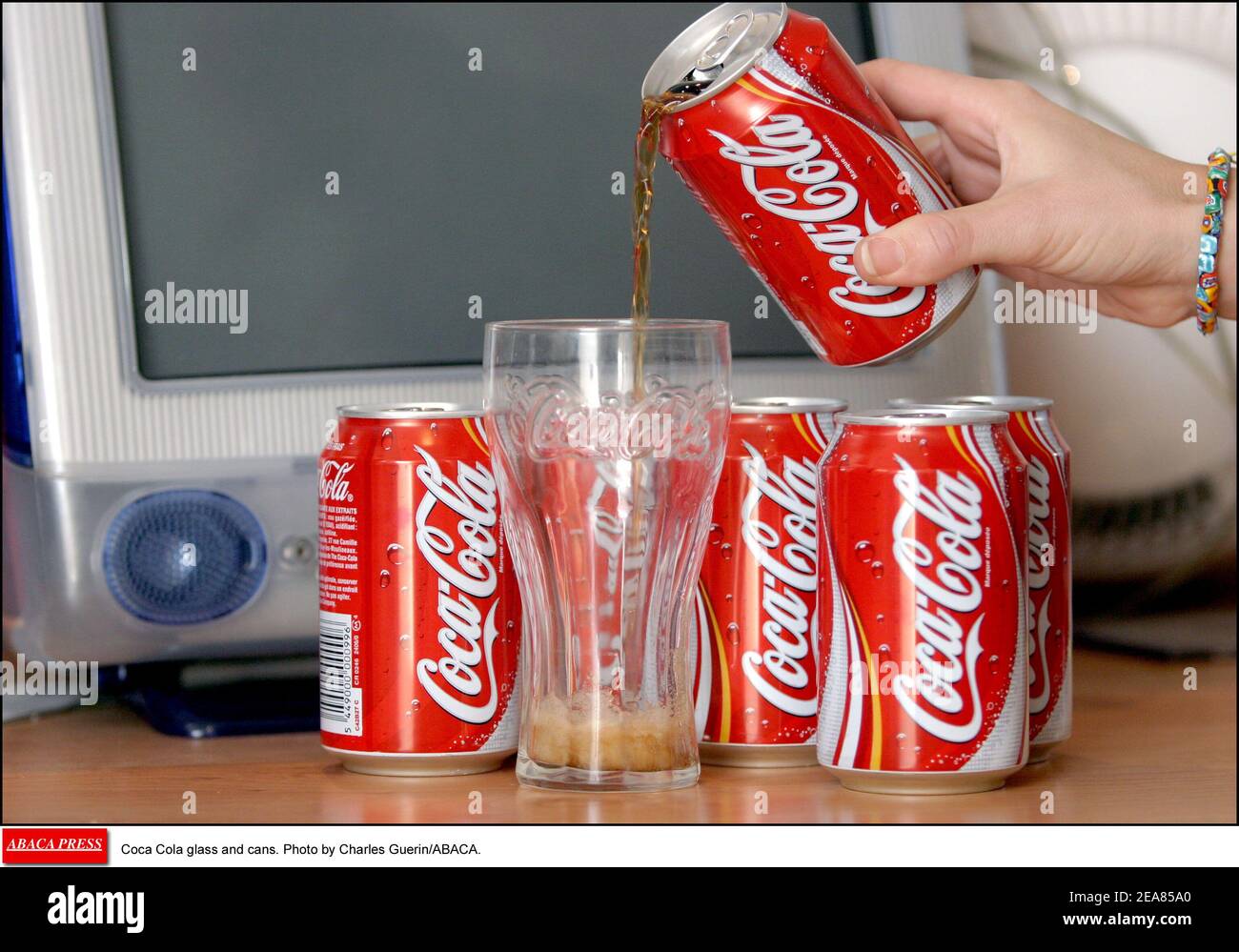 Coca Cola glass and cans. Photo by Charles Guerin/ABACA Stock Photo - Alamy