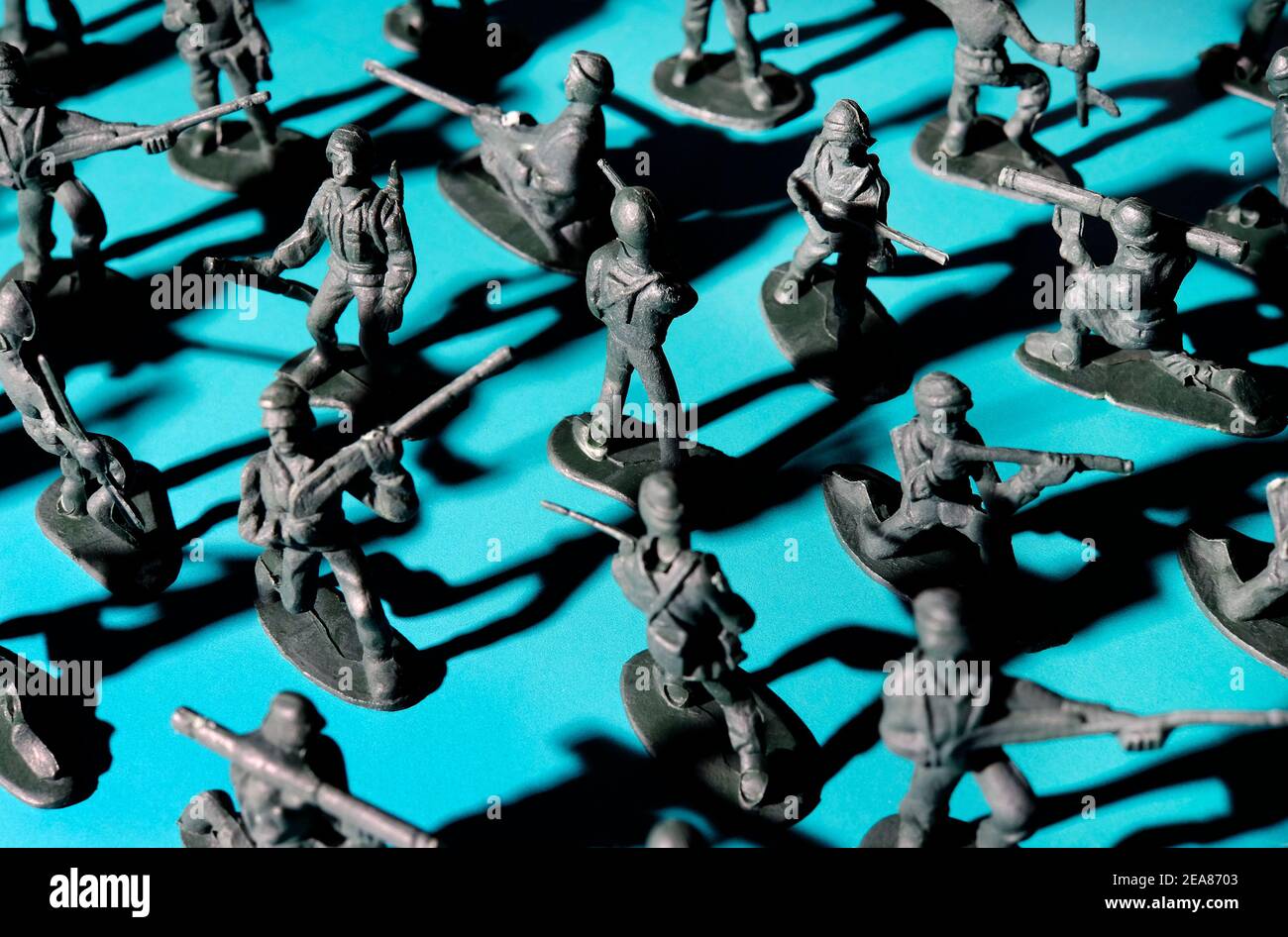 green miniature toy soldiers on blue background Stock Photo - Alamy