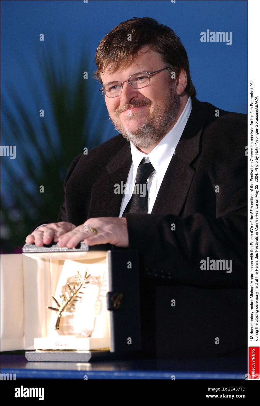 US documentary-maker Michael Moore poses with the Palme d'Or of the ...