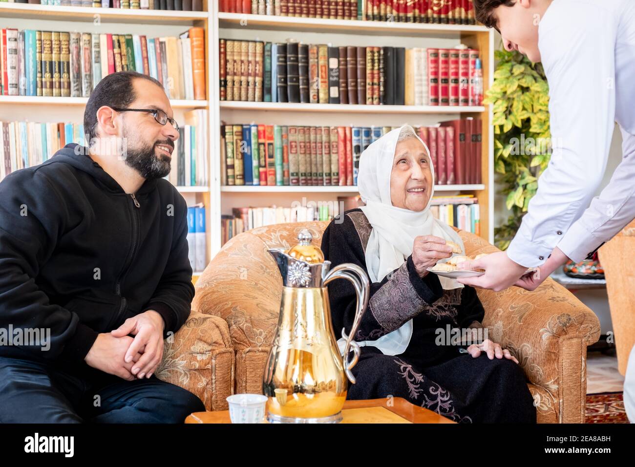 Family enjoy the eid celebration and serving guests Stock Photo - Alamy
