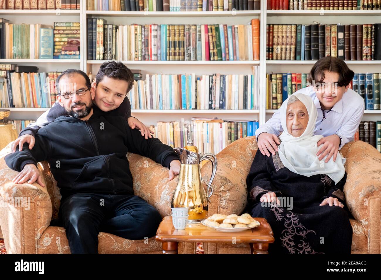 Family enjoy the eid celebration and serving guests Stock Photo - Alamy