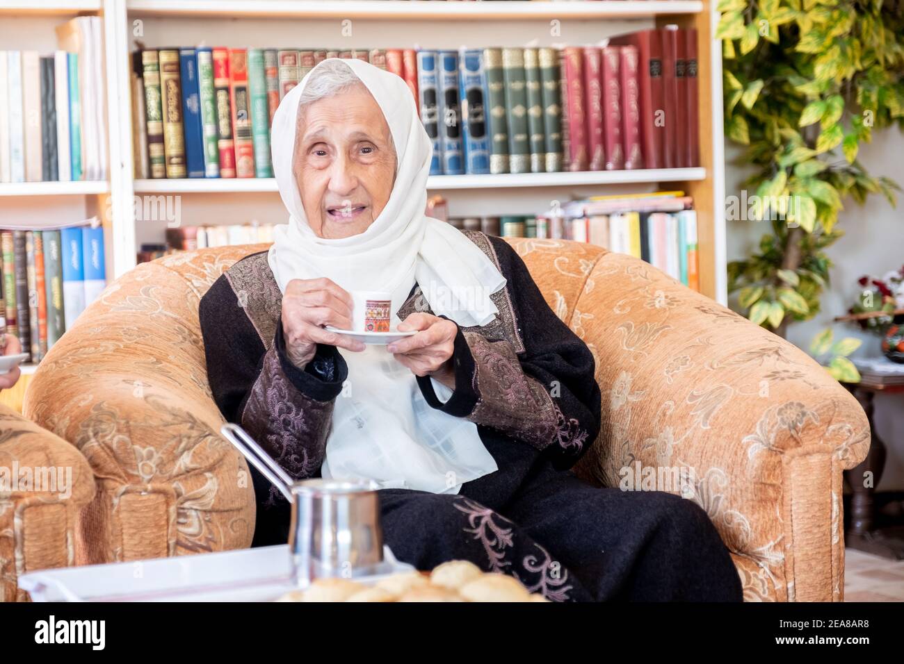 Family enjoy the eid celebration and serving guests Stock Photo - Alamy