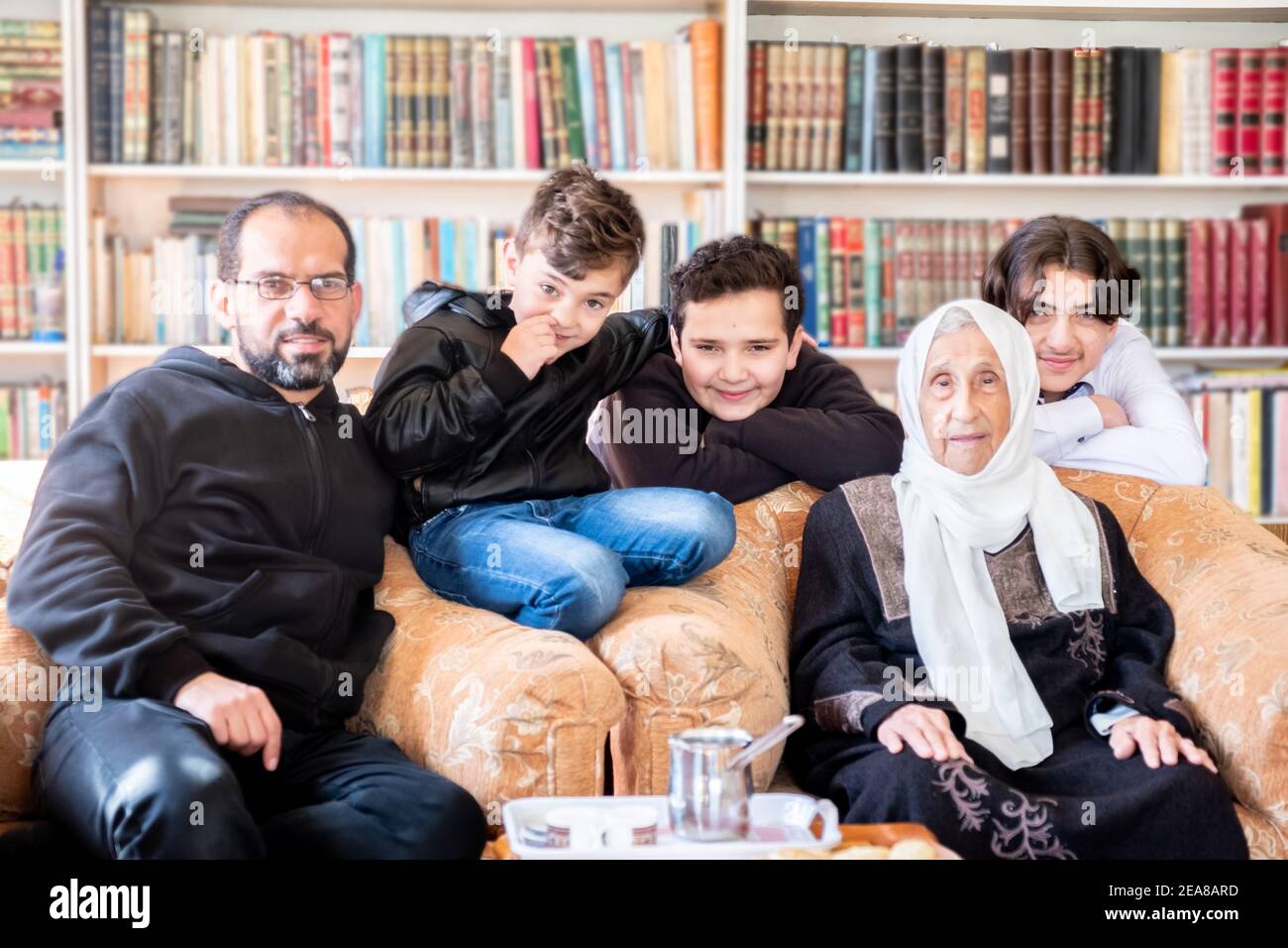 Family enjoy the eid celebration and serving guests Stock Photo - Alamy