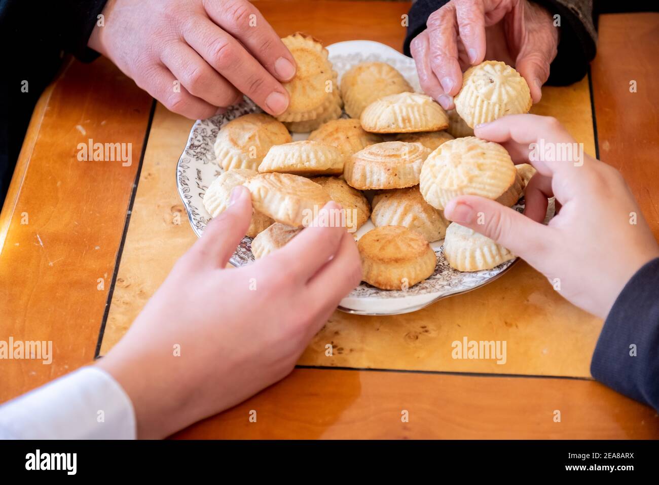 Arabic family eating sweets together and drinking coffee Stock Photo ...