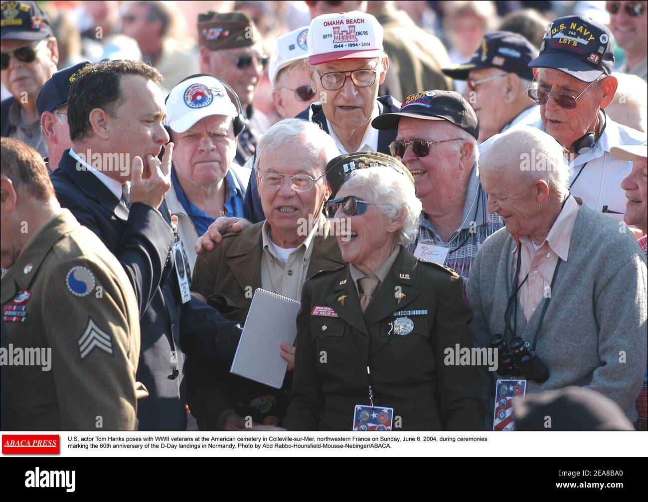 U.S. actor Tom Hanks poses with WWII veterans at the American cemetery ...