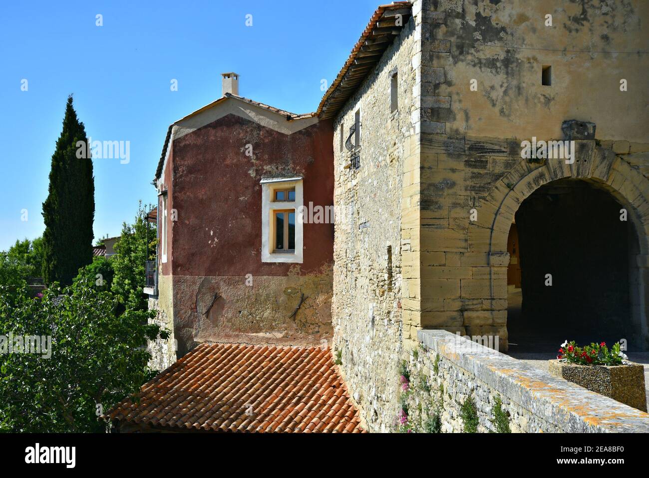 Old traditional rural houses on the main street of Venasque in Vaucluse ...